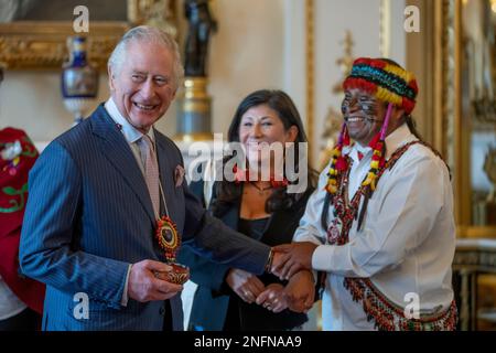 Amazon Indigenous leader Domingo Peas (right), presents a gift to King ...