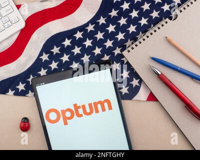 In this photo illustration, Optum, Inc. logo seen displayed on a tablet ...