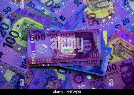 To verify the authenticity of the money. 20,000 HUF banknote in UV ...