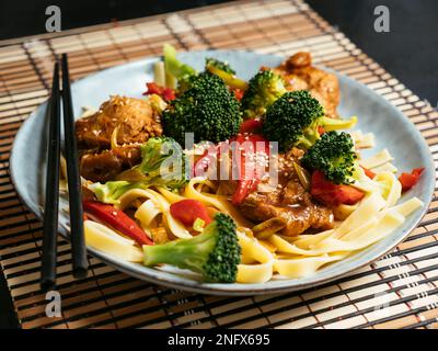 Broccoli, TVP Medallion Stir Fry on Noodles Stock Photo - Alamy