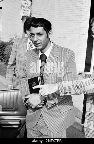 Joseph Kallinger of Philadelphia, his handcuffed wrists carrying a ...