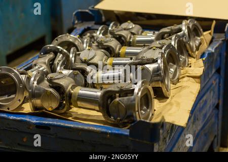 Cardan shafts and gimbal transmissions laying in box during production ...