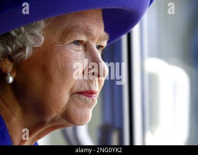 Queen Elizabeth II looks out of the window of Buckingham Palace, in ...
