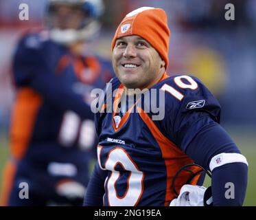 Denver Broncos punter Todd Sauerbrun takes a snap from a machine during ...