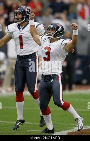 Houston Texans holder Matt Turk (1) and kicker Neil Rackers (4) follows ...