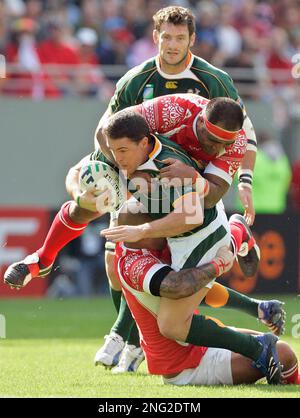 Andre Pretorius of South Africa, foreground with ball, is being tackled ...
