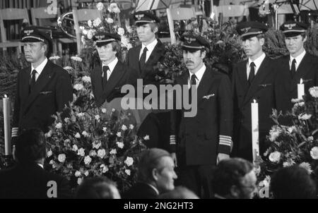Pilots of the West German Lufthansa airline stand beside the coffin as ...