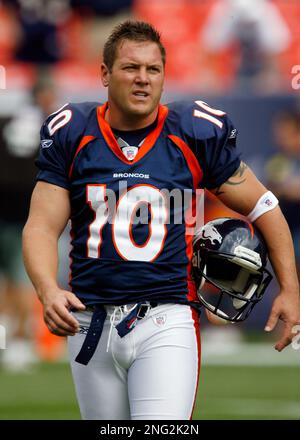 Denver Broncos punter Todd Sauerbrun takes a snap from a machine during ...