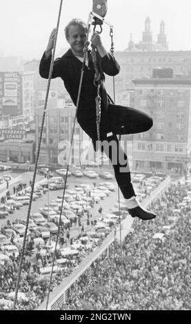 Upside Down Straight Jacket Escape man tied up hanging upside down by a ...