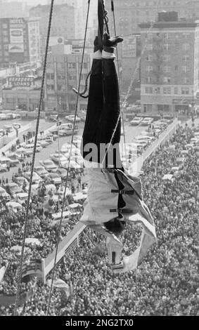 Upside Down Straight Jacket Escape man tied up hanging upside down by a ...