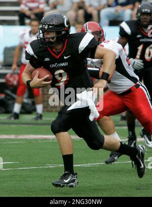Cincinnati quarterback Ben Mauk runs upfield against West Virginia in ...