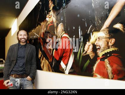 Artist Greg Semu of New Zealand stands next to his photo hanging at the ...