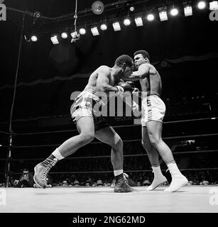 Zora Folley, left, moves in on champion Cassius Clay (Muhammad Ali) in ...