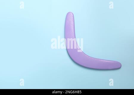 Wooden boomerang on light blue background. Space for text Stock Photo ...