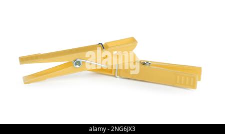 Bright yellow plastic clothespins on white background Stock Photo - Alamy