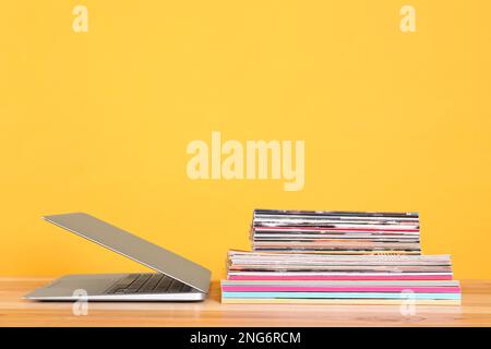 Laptop and stack of magazines on wooden table. Space for text Stock ...