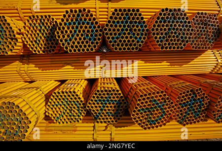 Yellow stacked steel pipe Stock Photo - Alamy