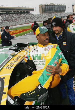 NASCAR driver Bill Lester climbs into is #23 Waste Management race car ...