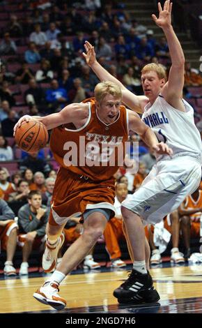 Texas forward Brad Buckman, left, grabs the defensive rebound during ...