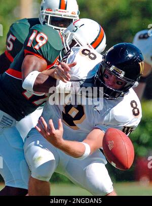 Wake Forest quarterback Ben Mauk, center, is taken down by Maryland's ...