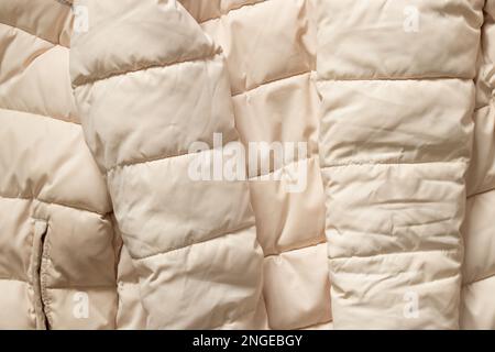 winter womens puffy white down jacket close up as background Stock ...