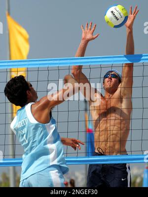 United States Beach Volleyball team captain Dax Holdren digs out a ...