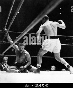 Defending heavyweight champion Rocky Marciano, in white trunks, knocks ...