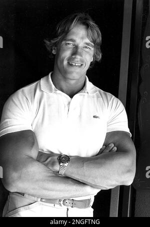 Bodybuilder-turned-actor Arnold Schwarzenegger puffs on a cigar prior ...