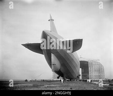 The giant German dirigible, Graf Zeppelin, is pulled down from the air ...
