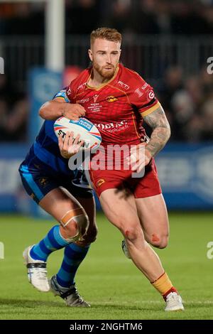 Adam Keighran #3 of Catalans Dragons tackles Marc Sneyd #7 of Salford ...
