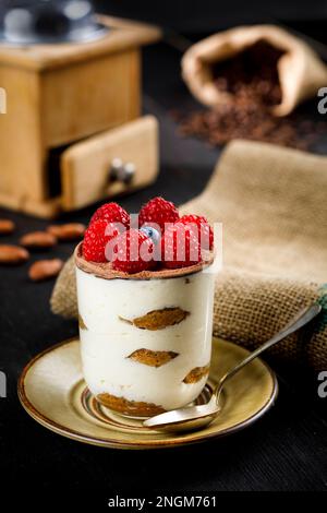 Tasty tiramisu dessert in glass, on wooden background Stock Photo - Alamy