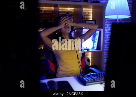 African american woman streamer stressed using computer at gaming room ...