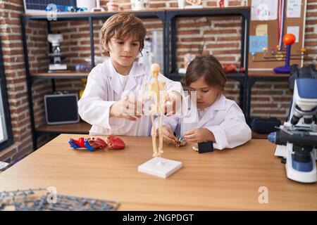 Brother and sister students having anatomy lesson at laboratory ...