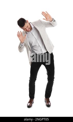 Emotional man evading something on white background Stock Photo - Alamy