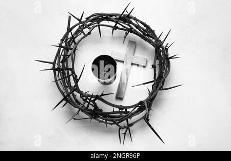 Wine cup, crown of thorns, cross and Holy Bible on dark background ...