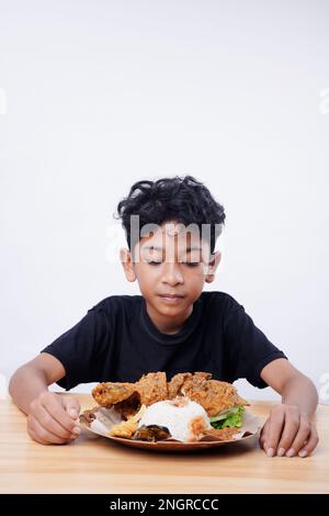 Boy eating Fried Fish and rice at lunch break at school Stock Photo - Alamy