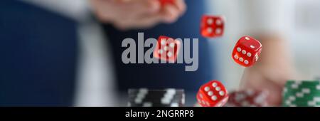 Five red dice are discarded from hand Stock Photo - Alamy