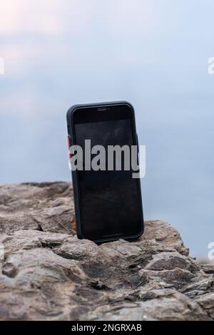 a black smartphone recording time lapse on the lake side Stock Photo ...