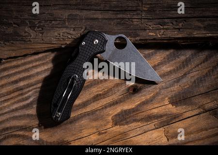 Folding knife in a bent position. Knife with clip for wearing Stock ...