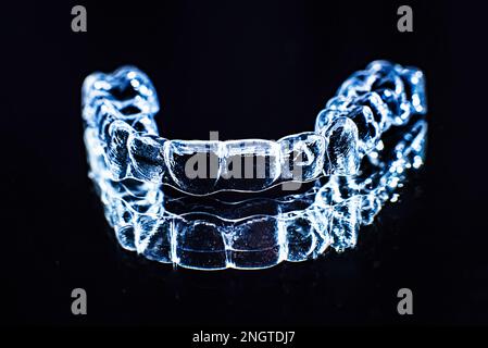 Invisible aligner teeth retainers on a pink background Stock Photo - Alamy