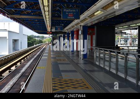 Metro train of LRT Kelana Jaya Line at Pasar Seni stop and skyscraper ...
