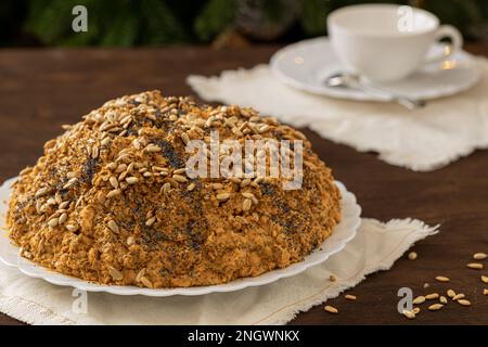 ant hill cake decorated with poppy seeds on a white plate. the concept ...