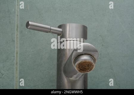 Dirty faucet aerator with limescale, calcified shower water tap with ...