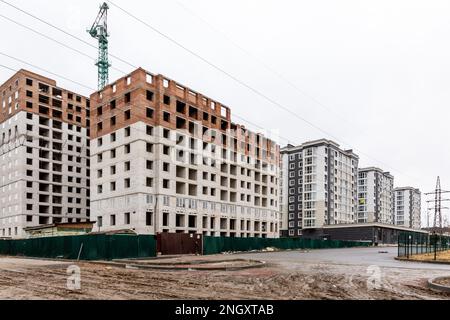 Bucha, Kyiv Oblast, Ukraine. 18th Feb, 2023. Builders cut wood to build ...