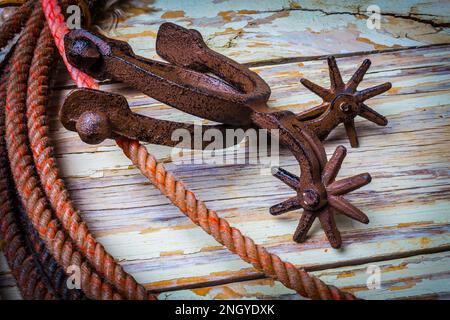 Rusty Spurs And Rope Stock Photo - Alamy