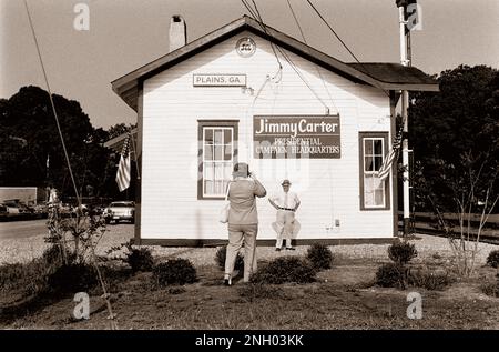 A tourist and supporter of Jimmy Carter takes a snapshot of her husband ...