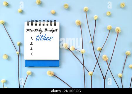 Tithe and offering as part of budget priority concept. Notepad with ...