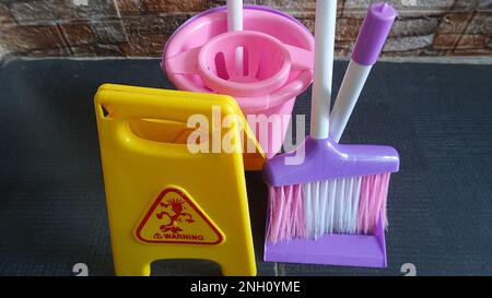 Children's games cleaning tools toy with warning wet signs as a means ...