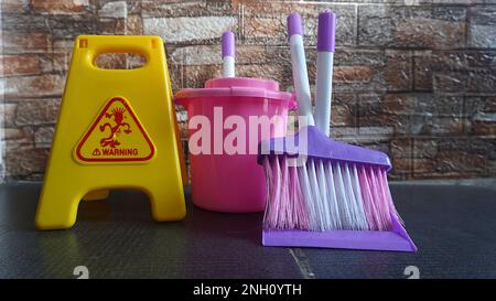 Children's games cleaning tools toy with warning wet signs as a means ...