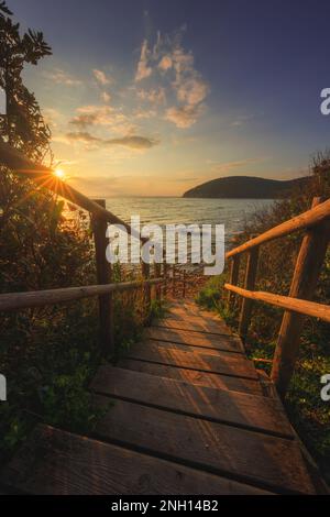 Descent to the sea in Cala Violina bay beach at sunset. Maremma ...
